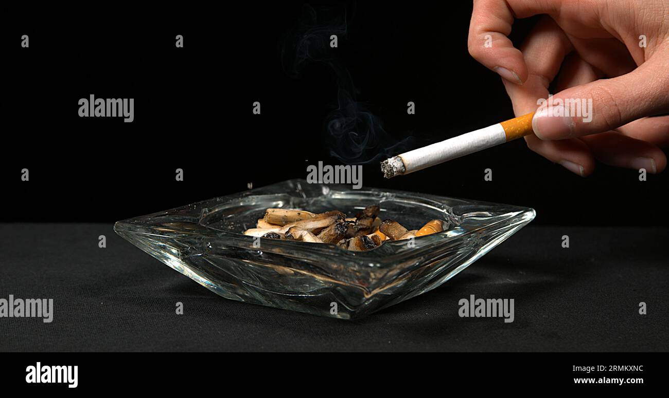 Hand of Woman with Cigarette and Ashtray Stock Photo - Alamy
