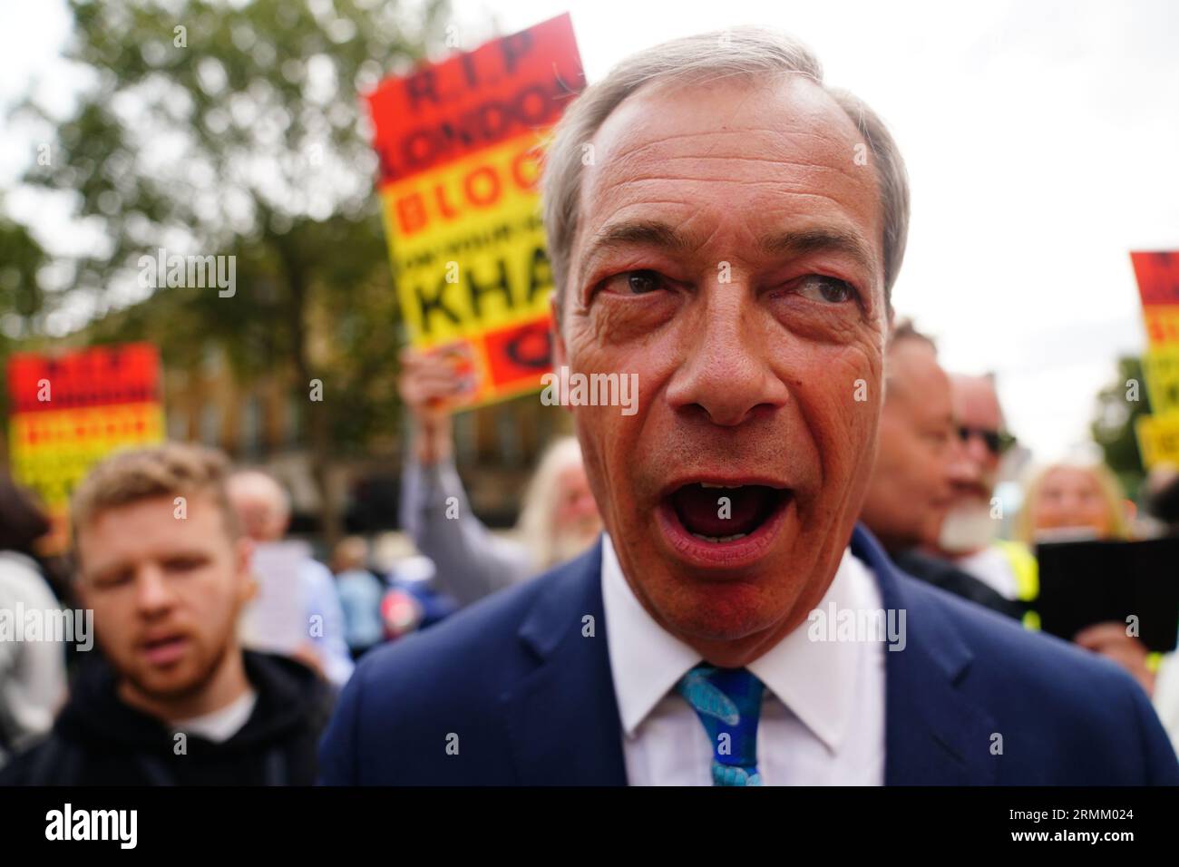 Nigel Farage speaks with protesters outside Downing Street in central ...