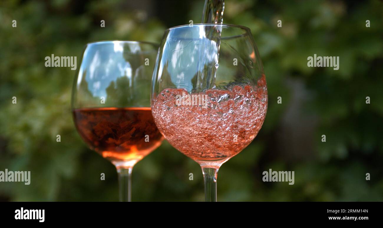 Pink wine flowing glass hi-res stock photography and images - Alamy