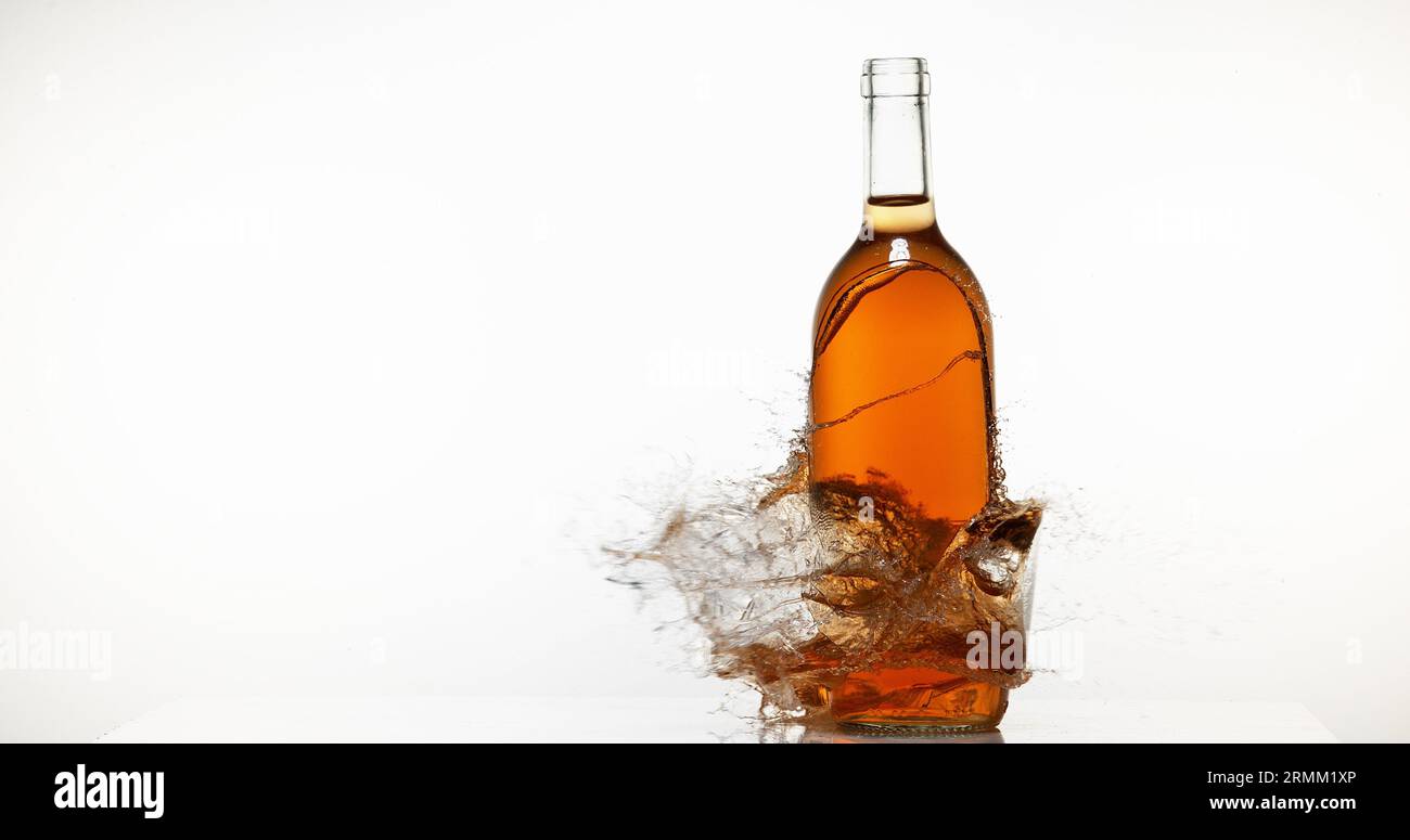 Bottle of Pink Wine Breaking and Splashing against White Background ...