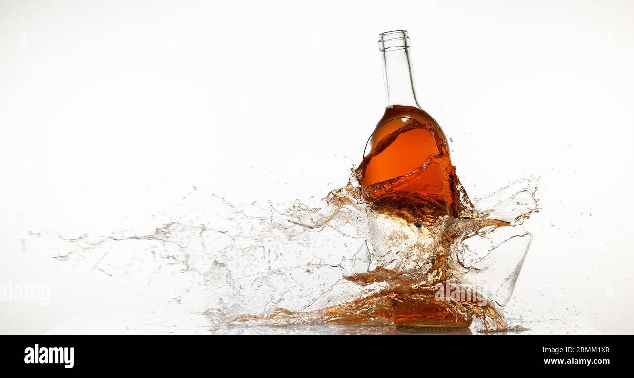 Bottle of Pink Wine Breaking and Splashing against White Background ...