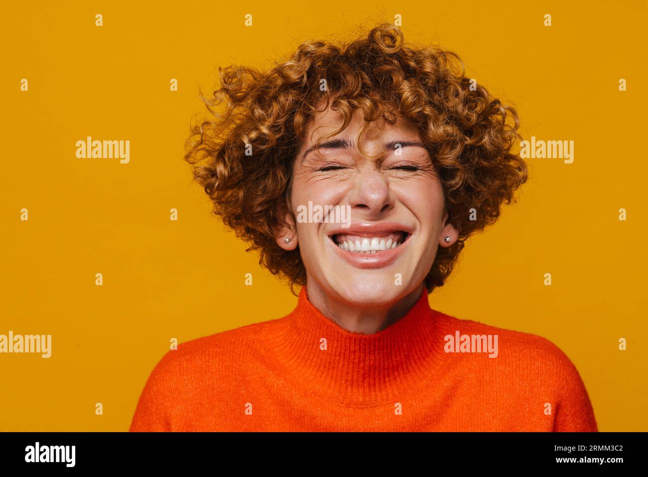 Excited ginger mature woman smiling with her eyes closed isolated over ...