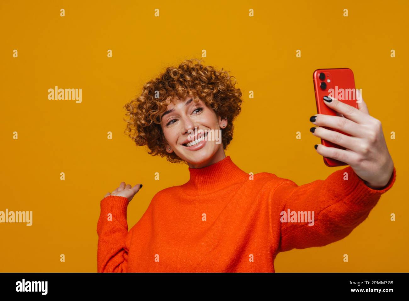 Middle-aged ginger woman waving hand while using mobile phone isolated ...