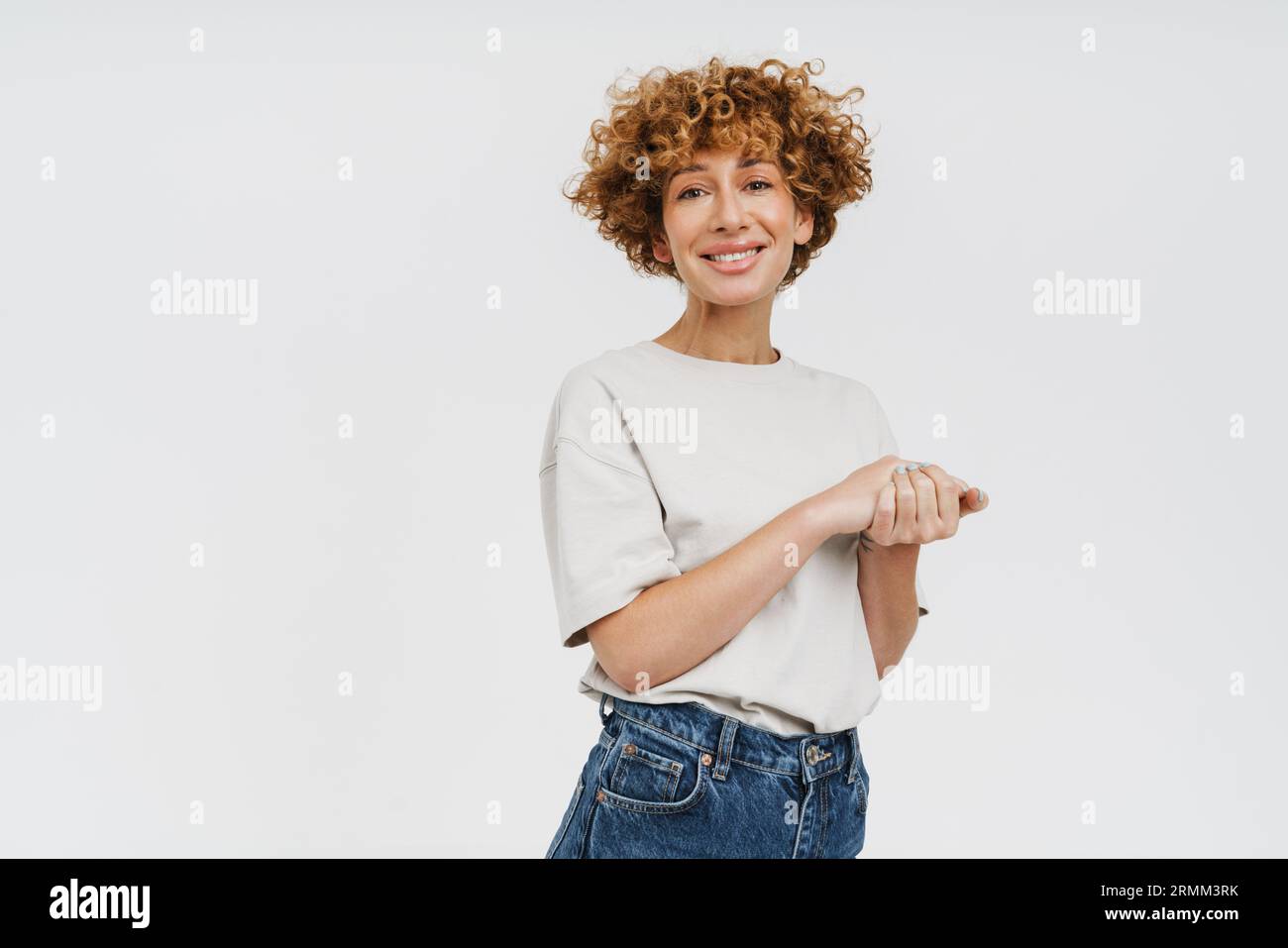 Middle-aged ginger woman smiling while standing isolated over white ...