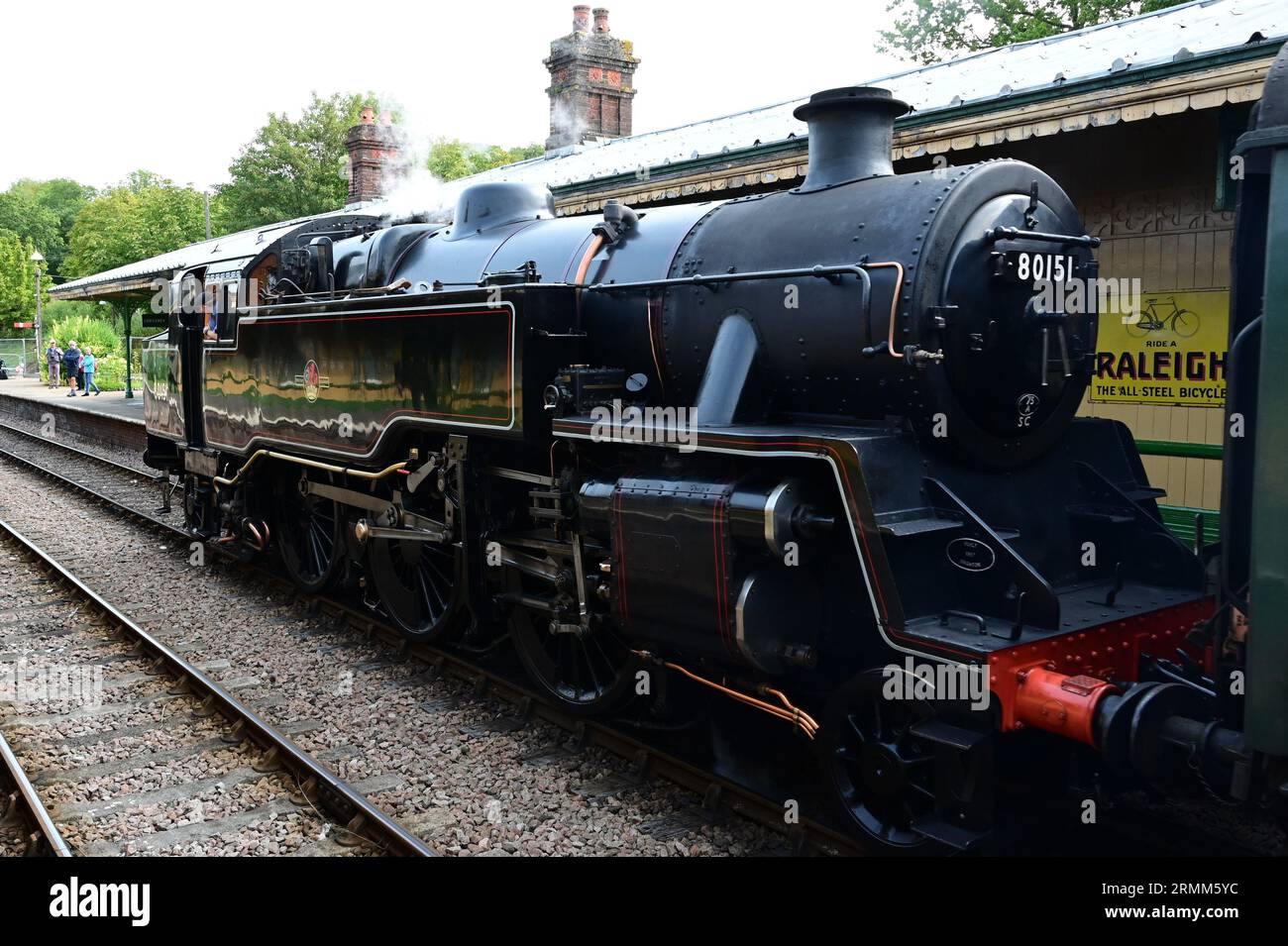A standard class 4MT tank engine pulling out of Horsted Keynes station ...