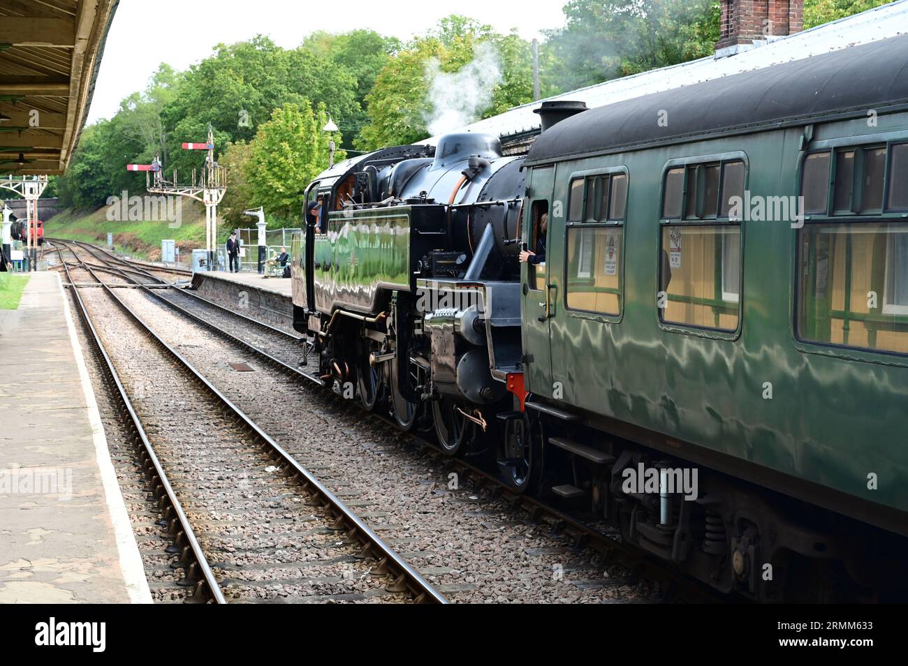 A standard class 4MT tank engine pulling out of Horsted Keynes station ...