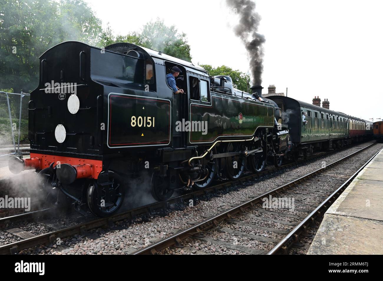A standard class 4MT tank engine pulling out of Horsted Keynes station ...