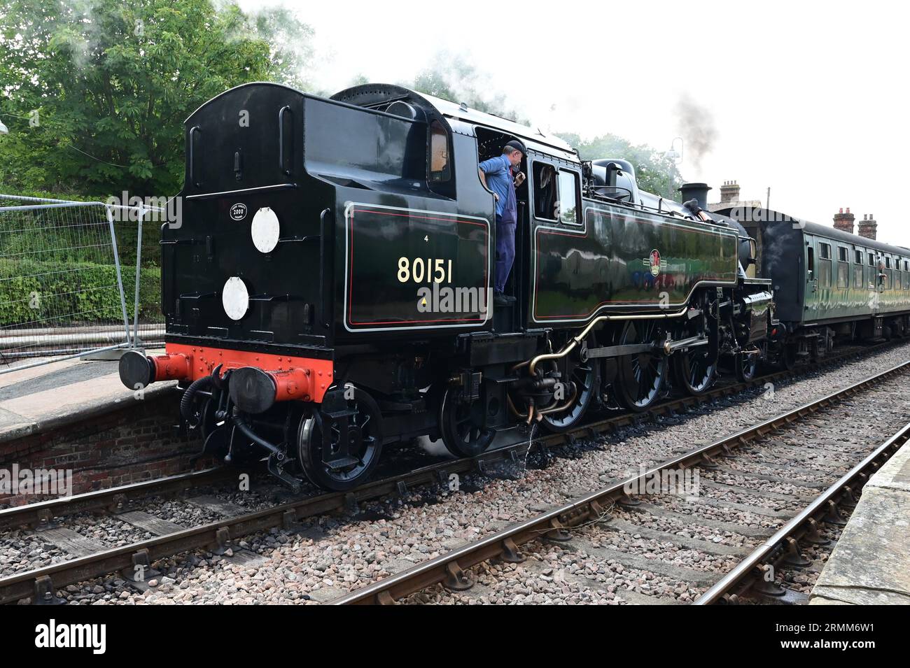 A standard class 4MT tank engine pulling out of Horsted Keynes station ...