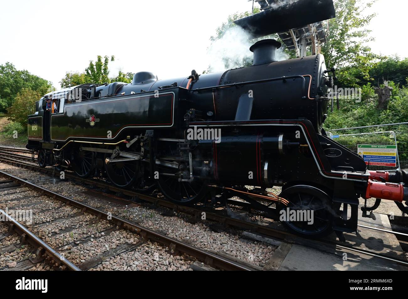 A standard class 4MT tank engine pulling out of Horsted Keynes station ...