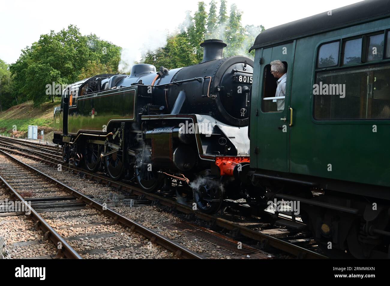 A standard class 4MT tank engine pulling out of Horsted Keynes station ...