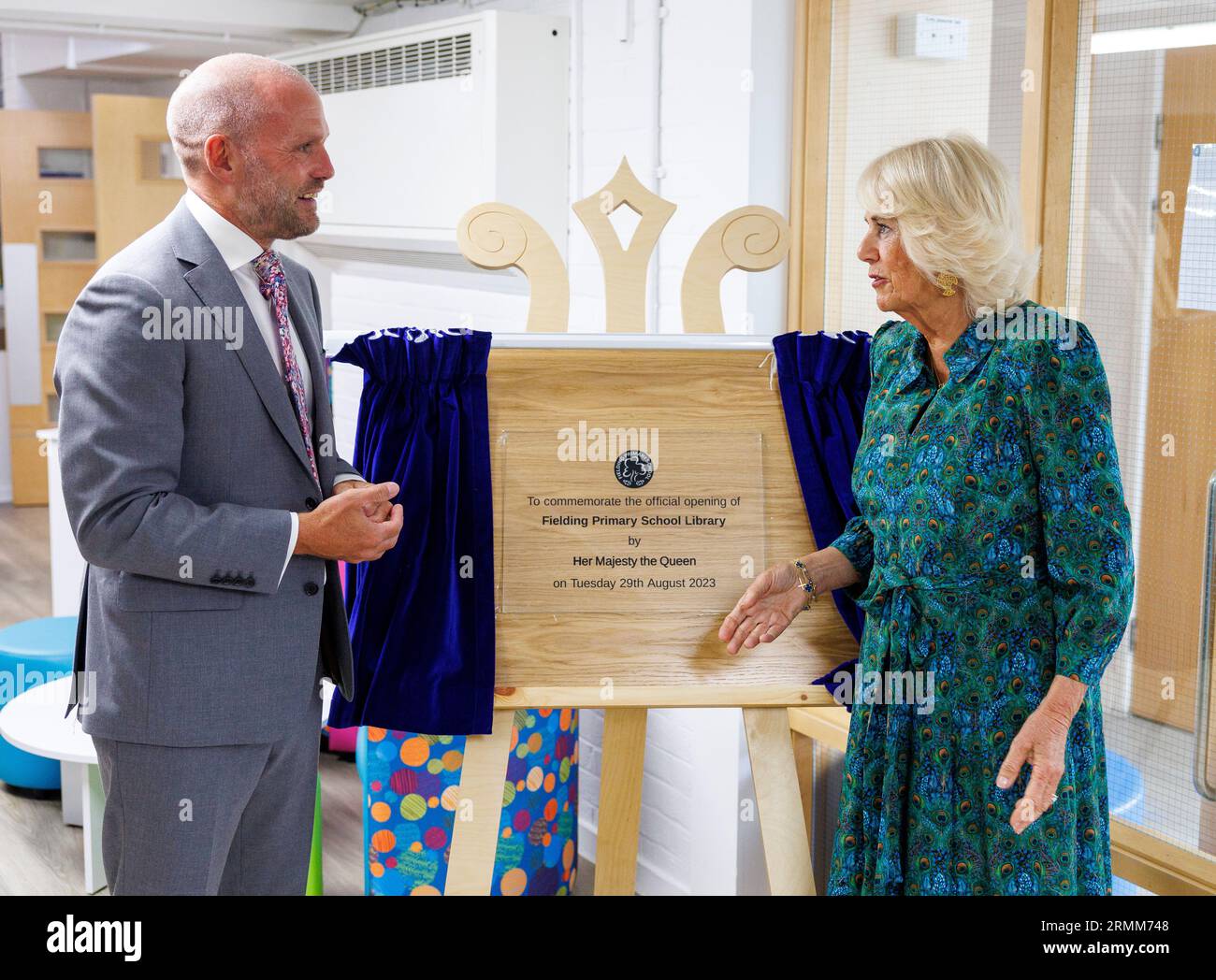 Queen Camilla officially opens the school library during a Poetry ...