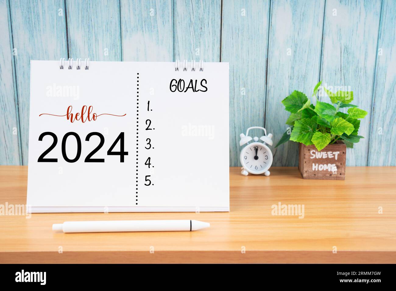 Hello 2024 with GOALS word on wooden table. time for a New Start ...