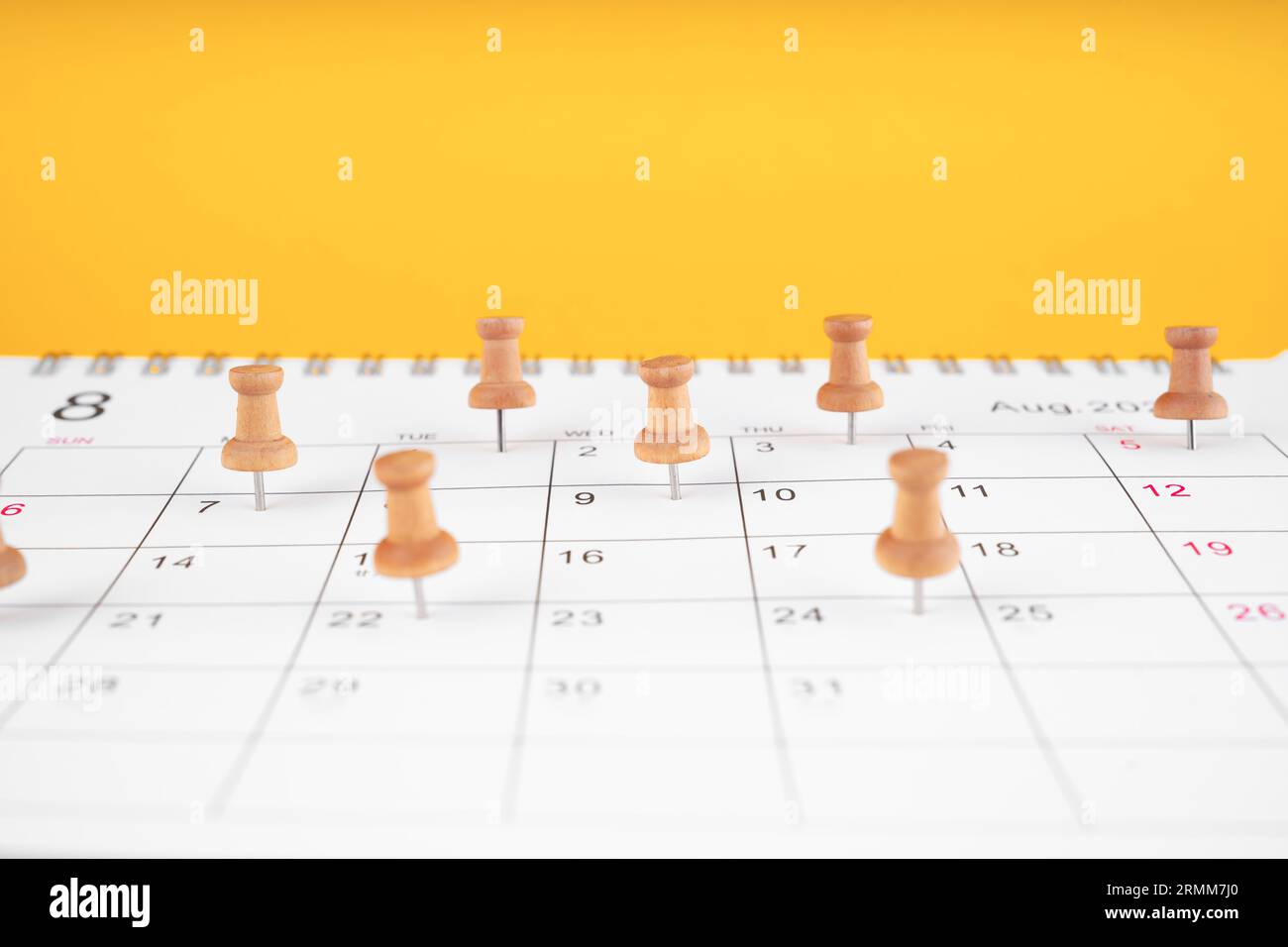 Wooden pin on the calendar indicates the schedule with yellow ...