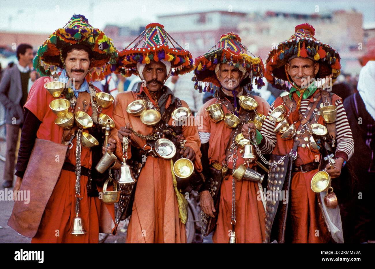 Morocco, Marrakech. Men in traditional clothing selling brass plates ...