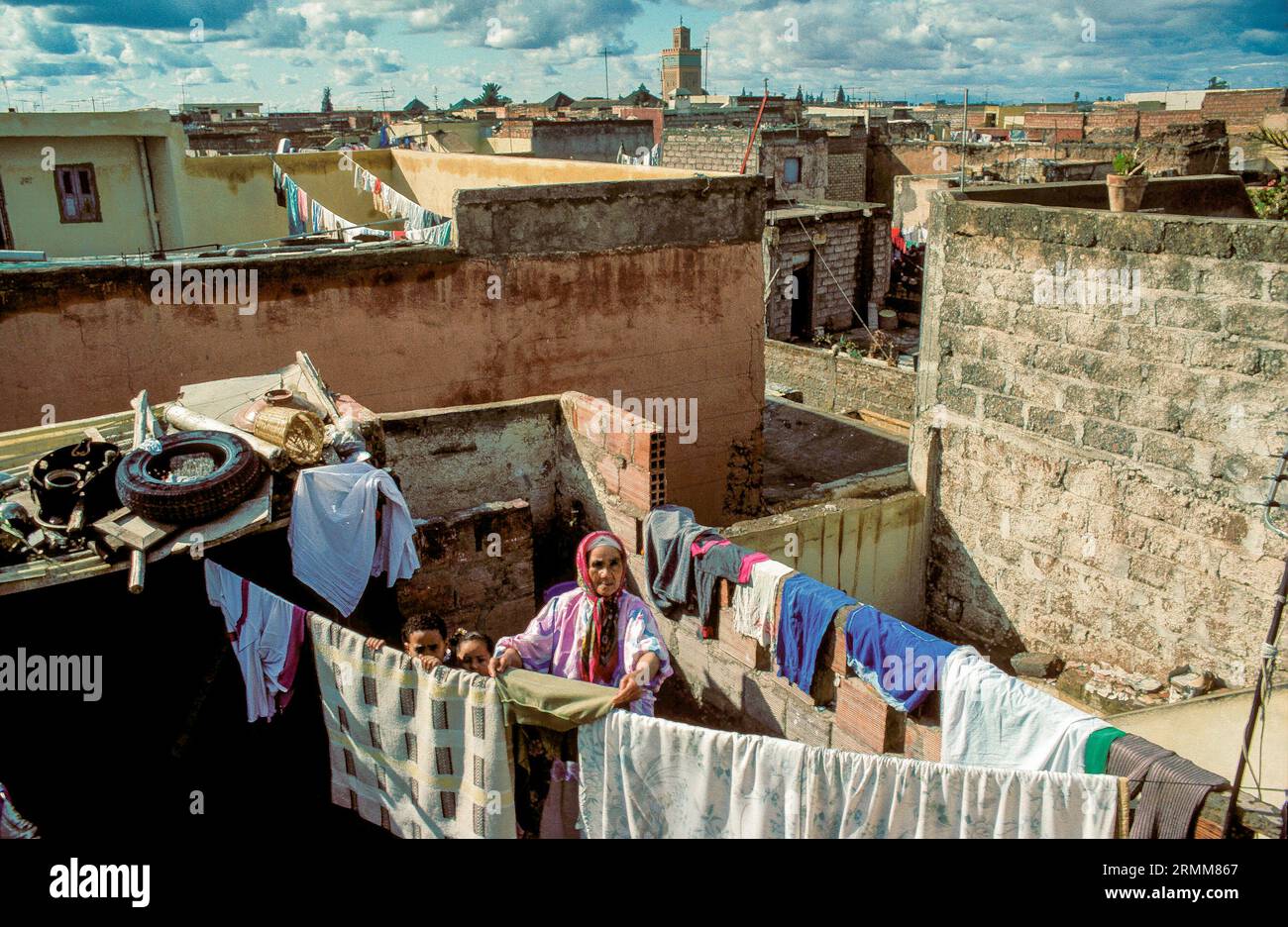 Morocco, Marrakech. Old woman is hanging out the laundry Stock Photo ...
