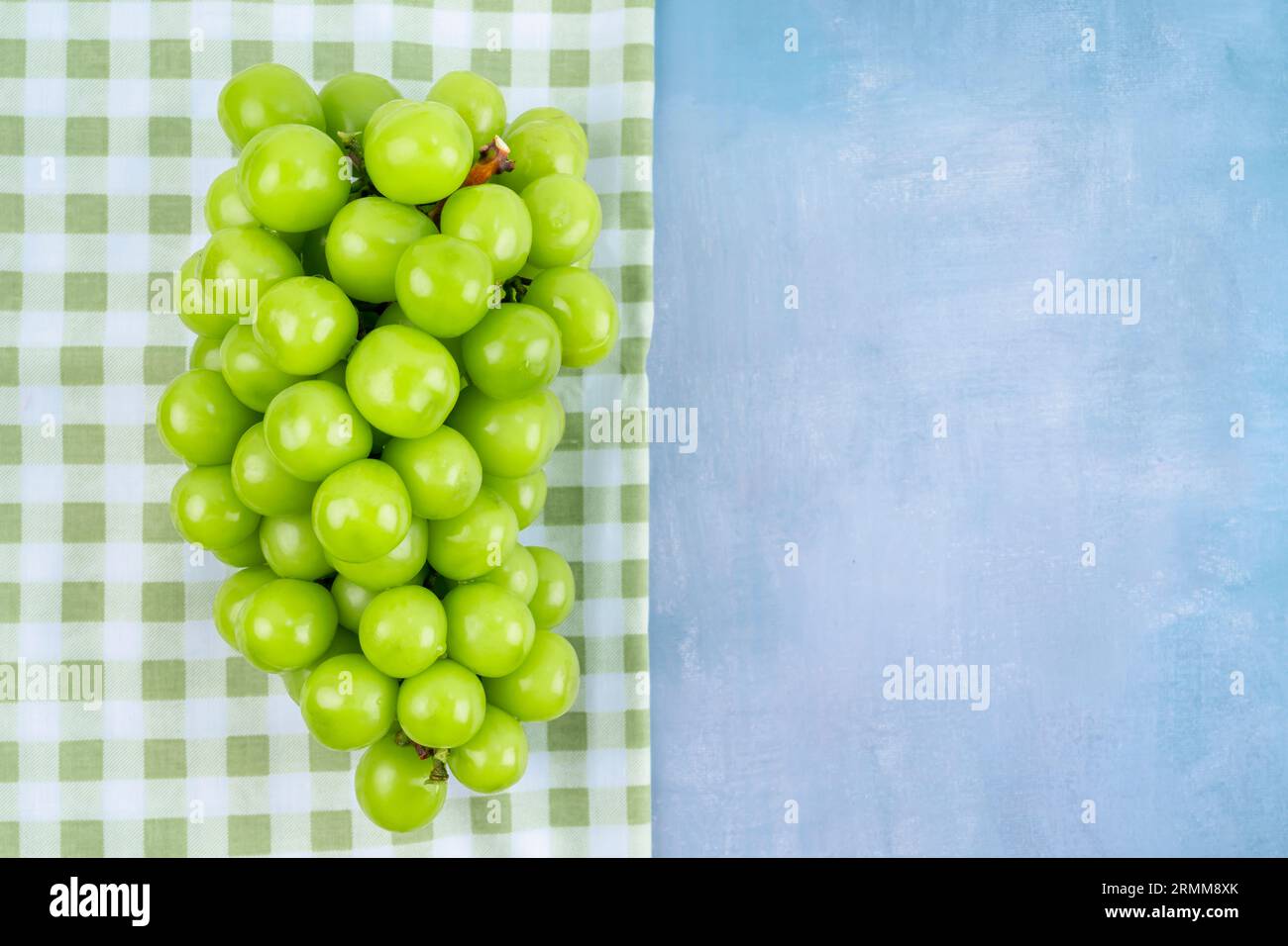 Japanese Shine Muscat Grape on tablecloth on wooden blue background ...