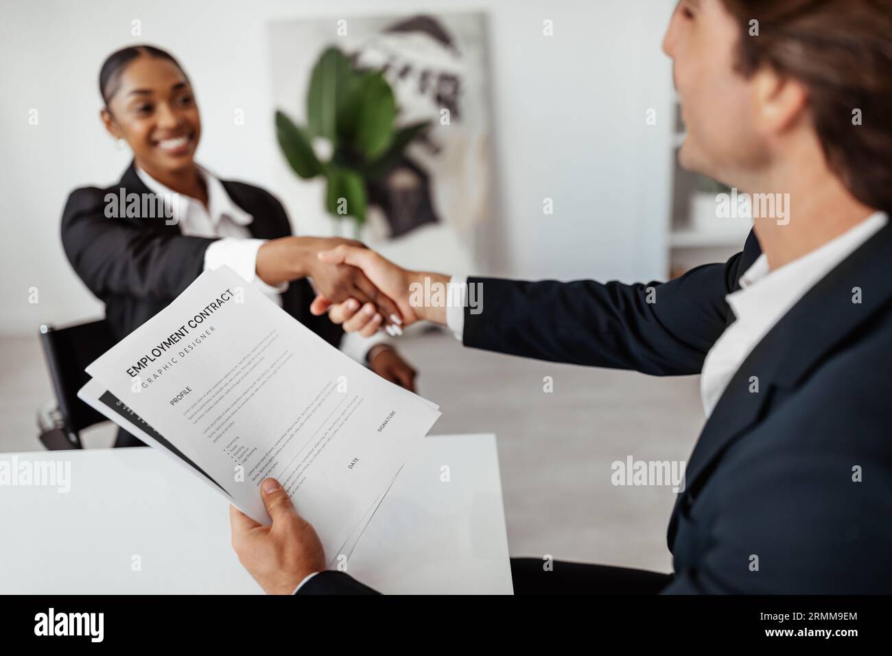 Successful job interview. Hired female candidate shaking hands with the ...
