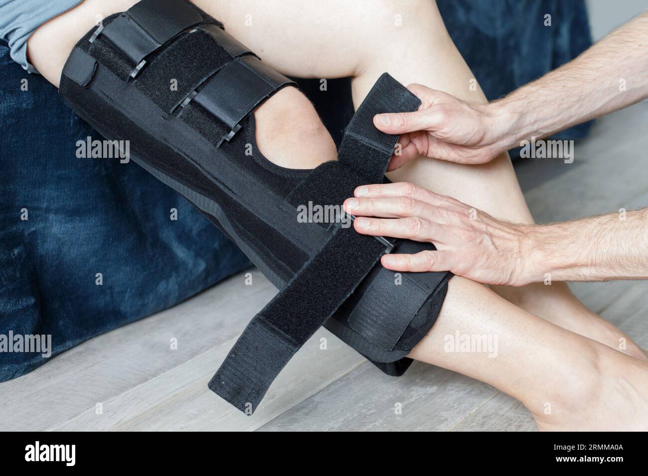 Closeup female leg in grey leggings dressed in knee brace to help ...