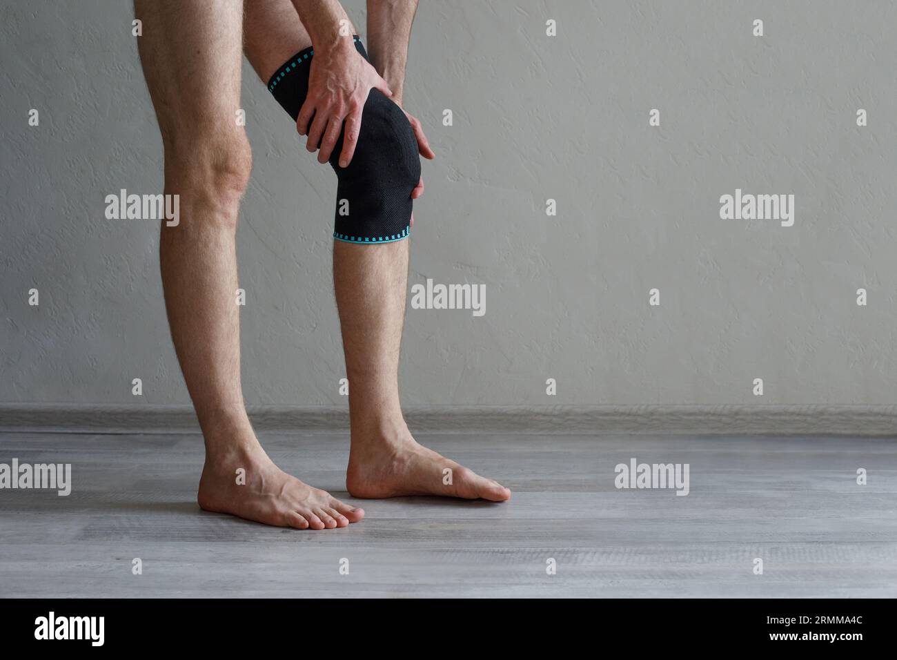 Male leg dressed in knee brace to help promote recovery of bones ...