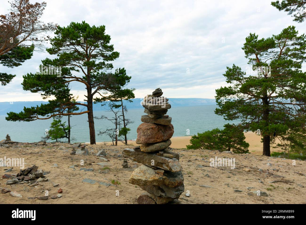 Zen Pyramid Stones and Larches on the Baikal Sand Beach Stock Photo - Alamy