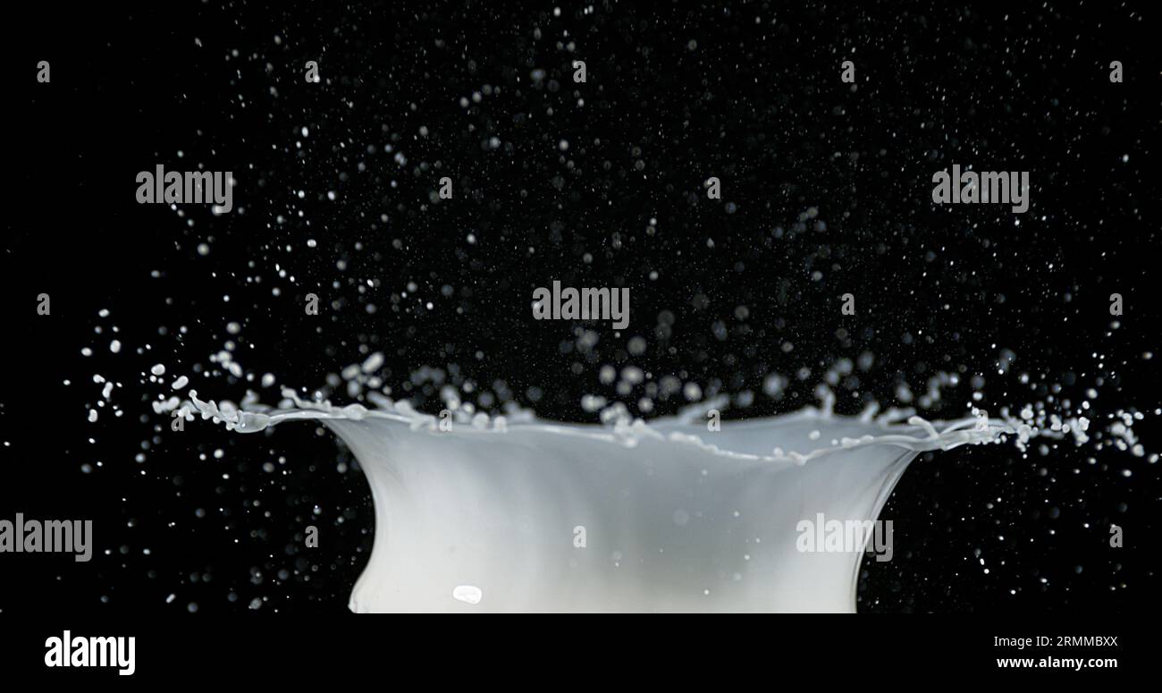 Exploding Milk against Black Background Stock Photo - Alamy