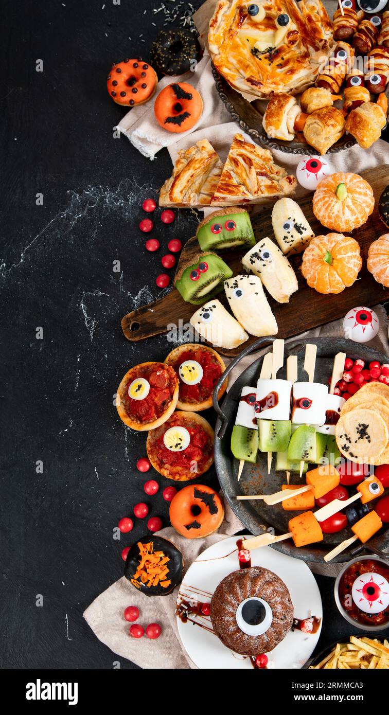 Fun Halloween dinner party table scene on a grey background. Top view ...