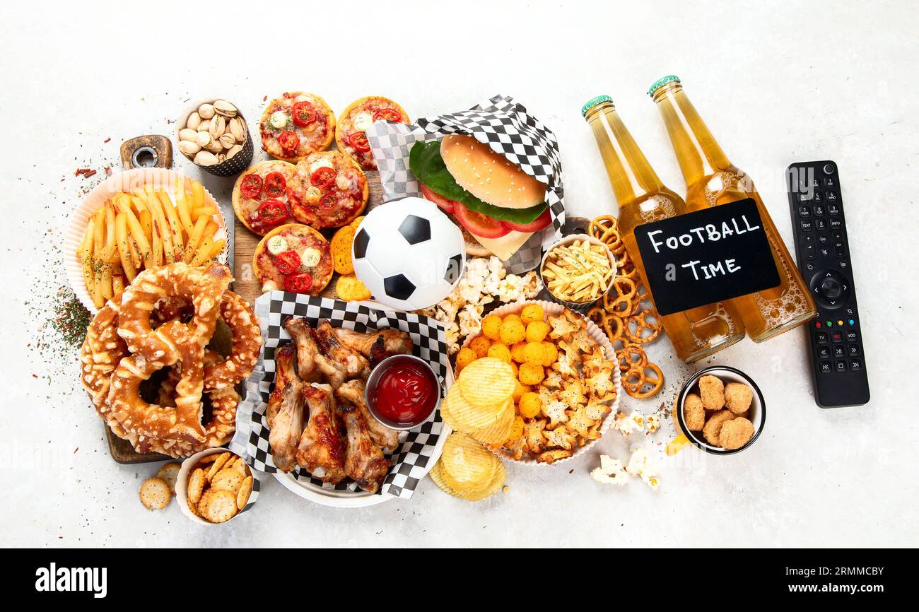 Table scene with large variety of take out and fast foods. Hamburger ...