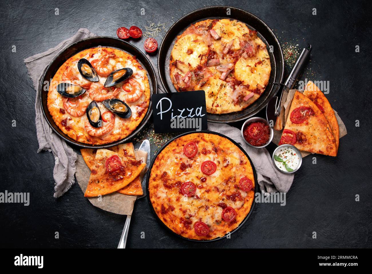 Assortment of various type of Italian pizza on a black background, top ...