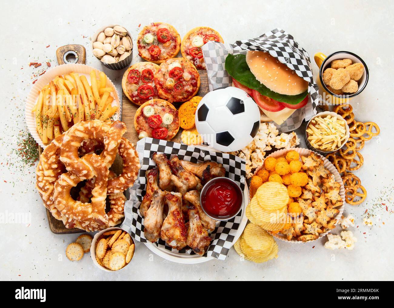 Table scene with large variety of take out and fast foods. Hamburger ...