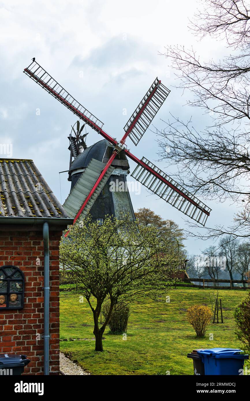 An idyllic rural landscape featuring a traditional windmill in the ...