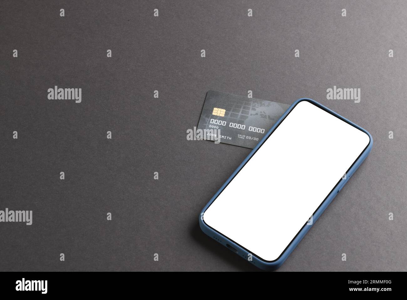 Smartphone with blank screen and credit card on black background Stock ...