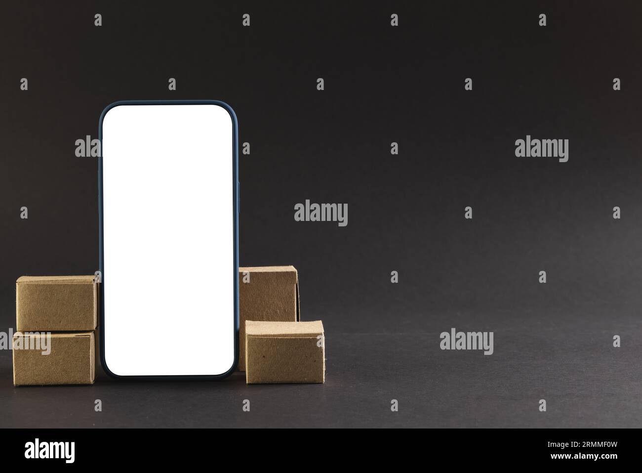 Smartphone with blank screen and cardboard boxes with copy space on ...