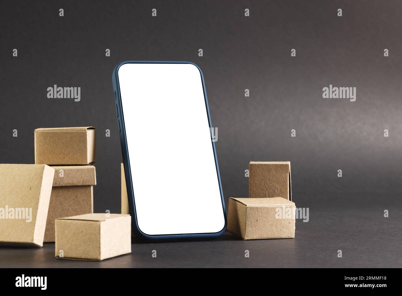 Smartphone with blank screen and cardboard boxes with copy space on ...
