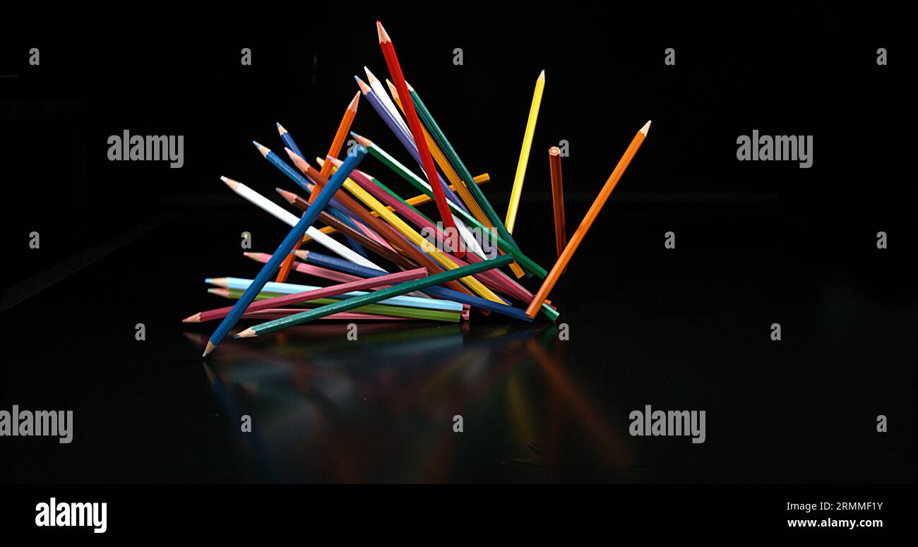 Color crayons falling against Black Background Stock Photo - Alamy