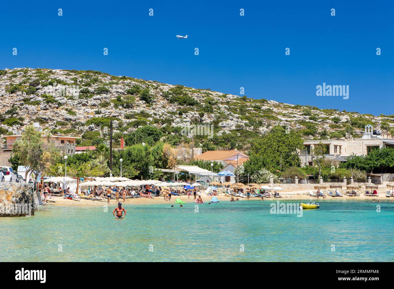 Swimmers and paddleboarders in the beautiful, clear, shallow waters of ...