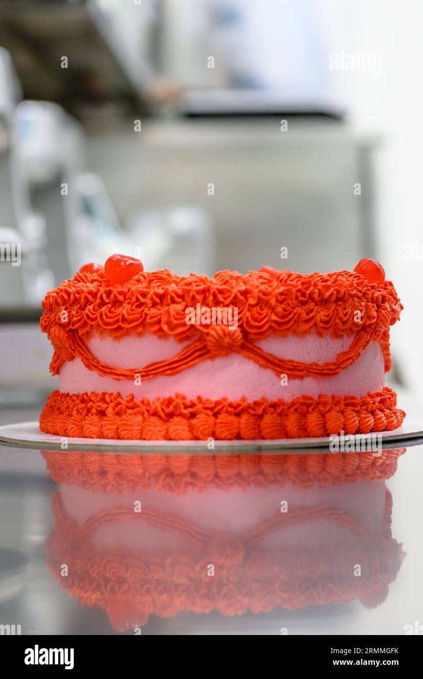 pastry chef making a pink red cupcake for birthday celebration , write ...