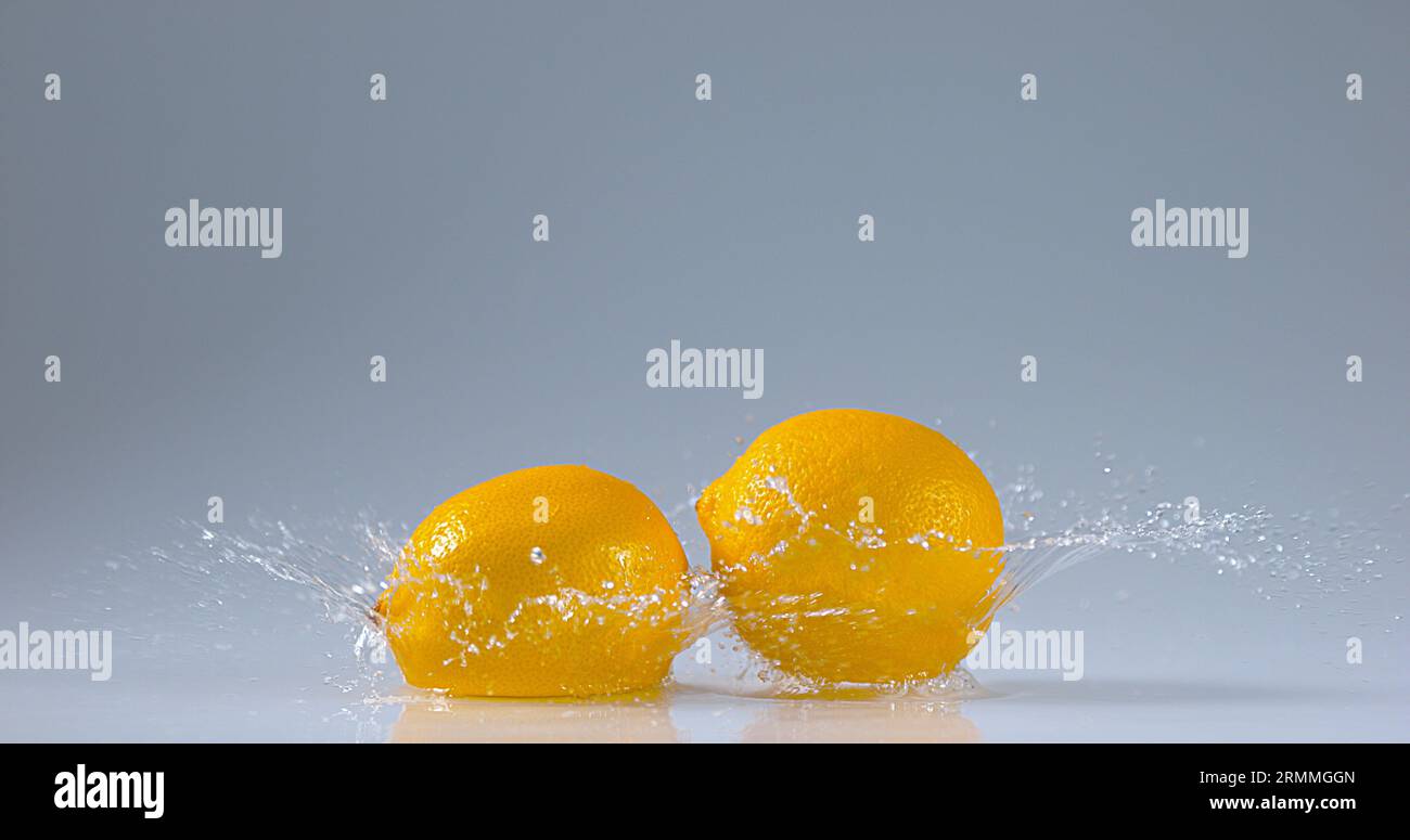Yellow Lemons, citrus limonum, Fruits falling on Water Stock Photo - Alamy