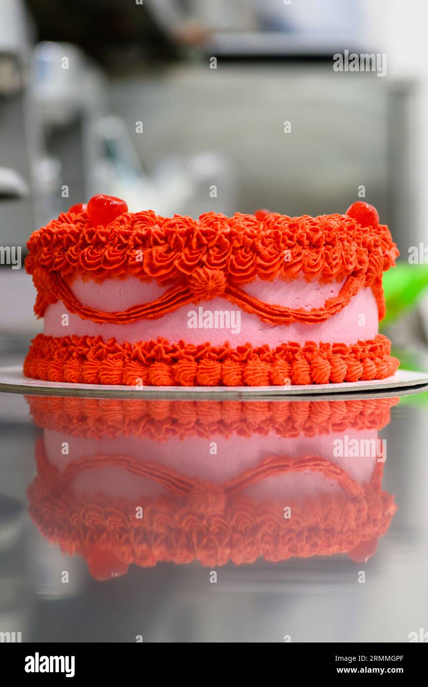 pastry chef making a pink red cupcake for birthday celebration , write ...