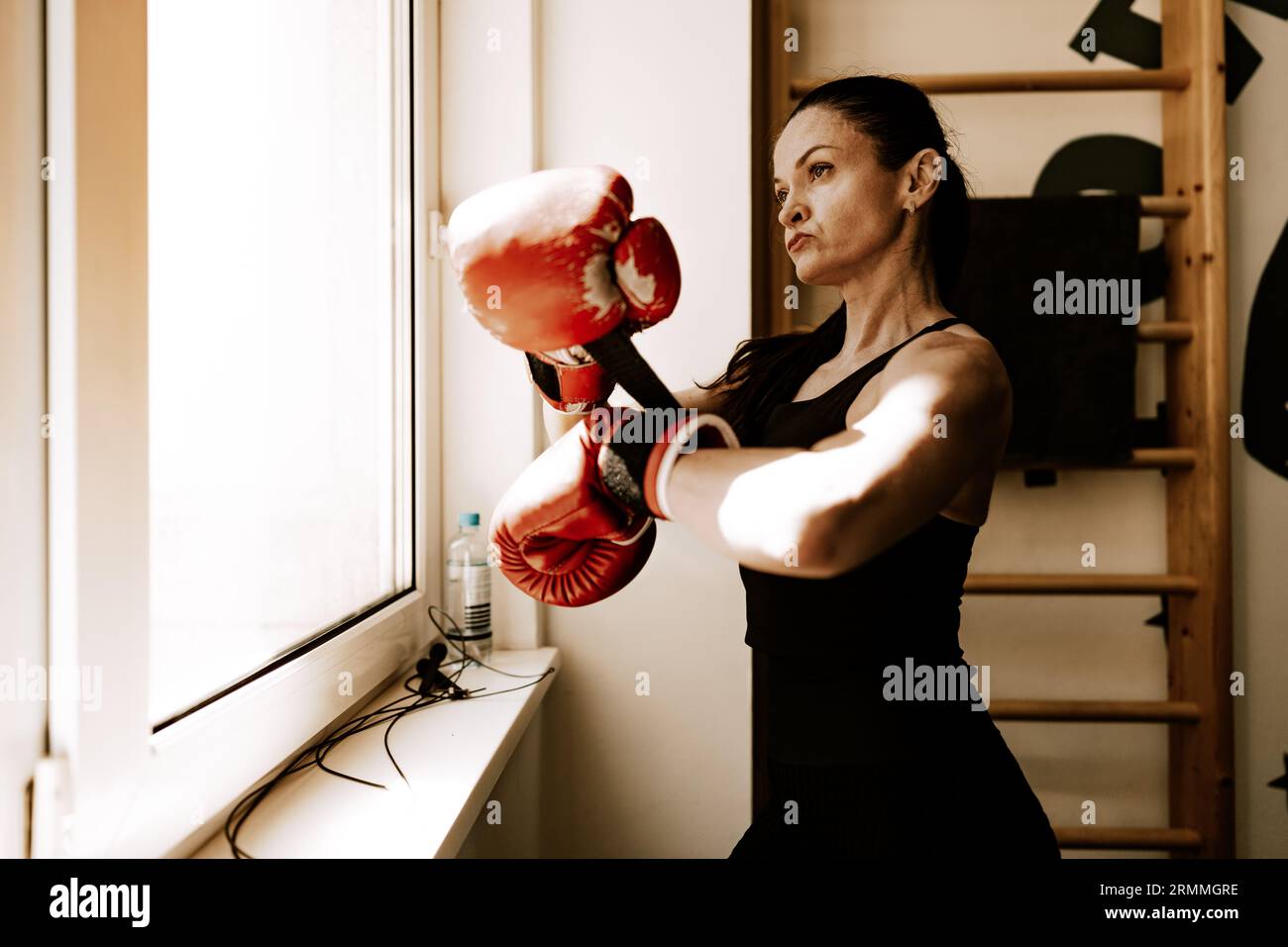 Fit woman in sportswear and red boxing gloves in a gym Stock Photo - Alamy