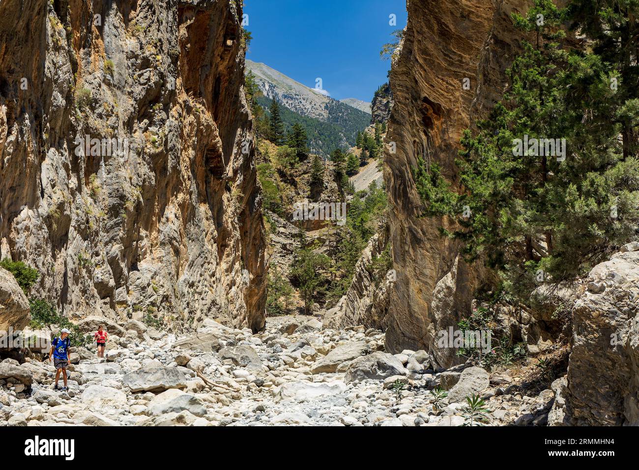 Hikers in the narrow, southern section of the Samaria Gorge on a hot ...