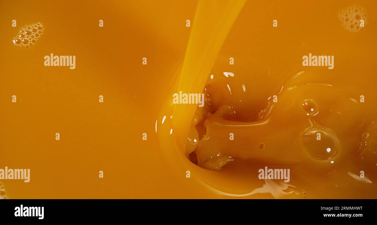 Orange Juice being poured Stock Photo - Alamy