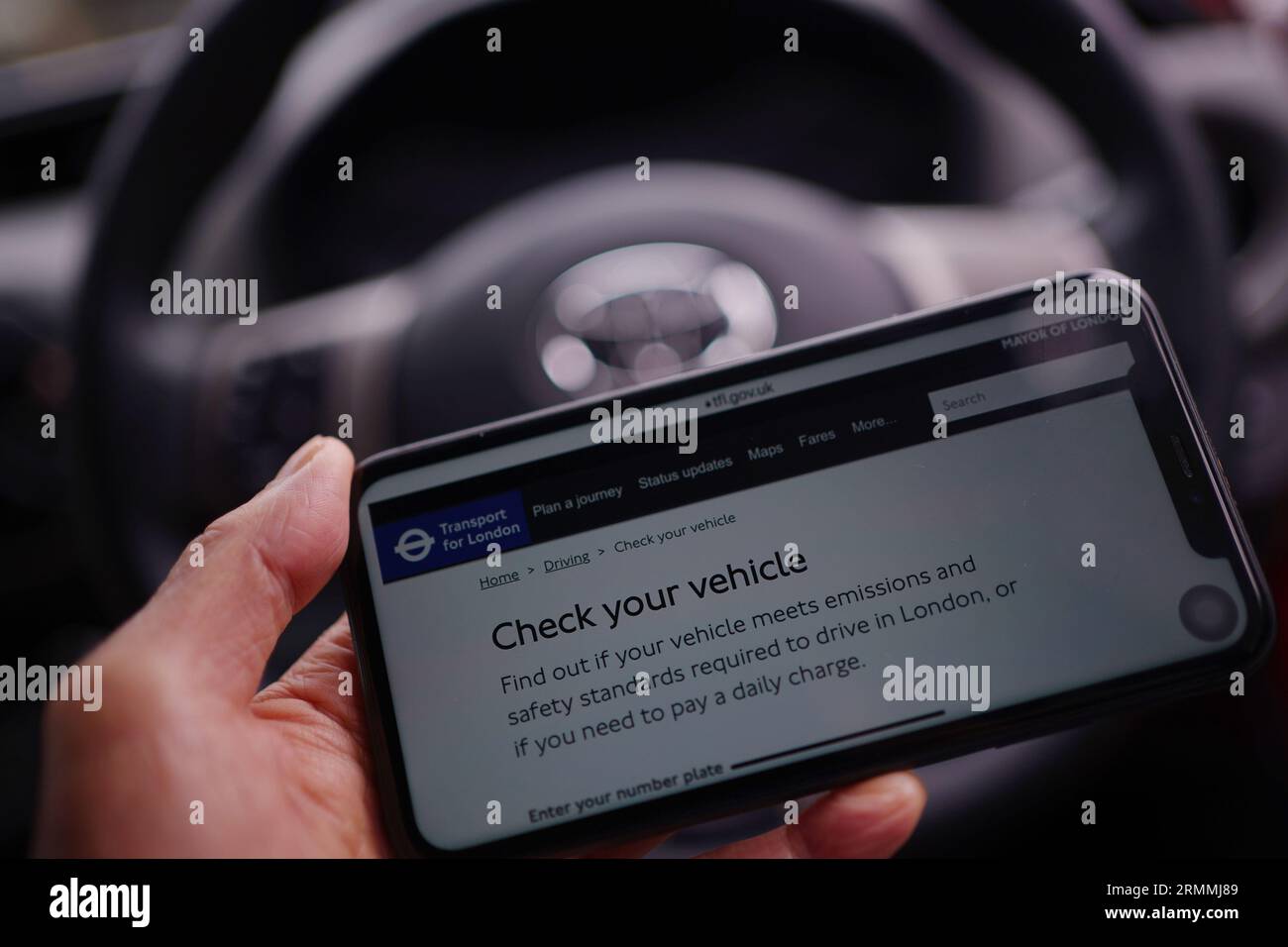 A person checks their vehicle on the Transport for London (TfL) webiste ...