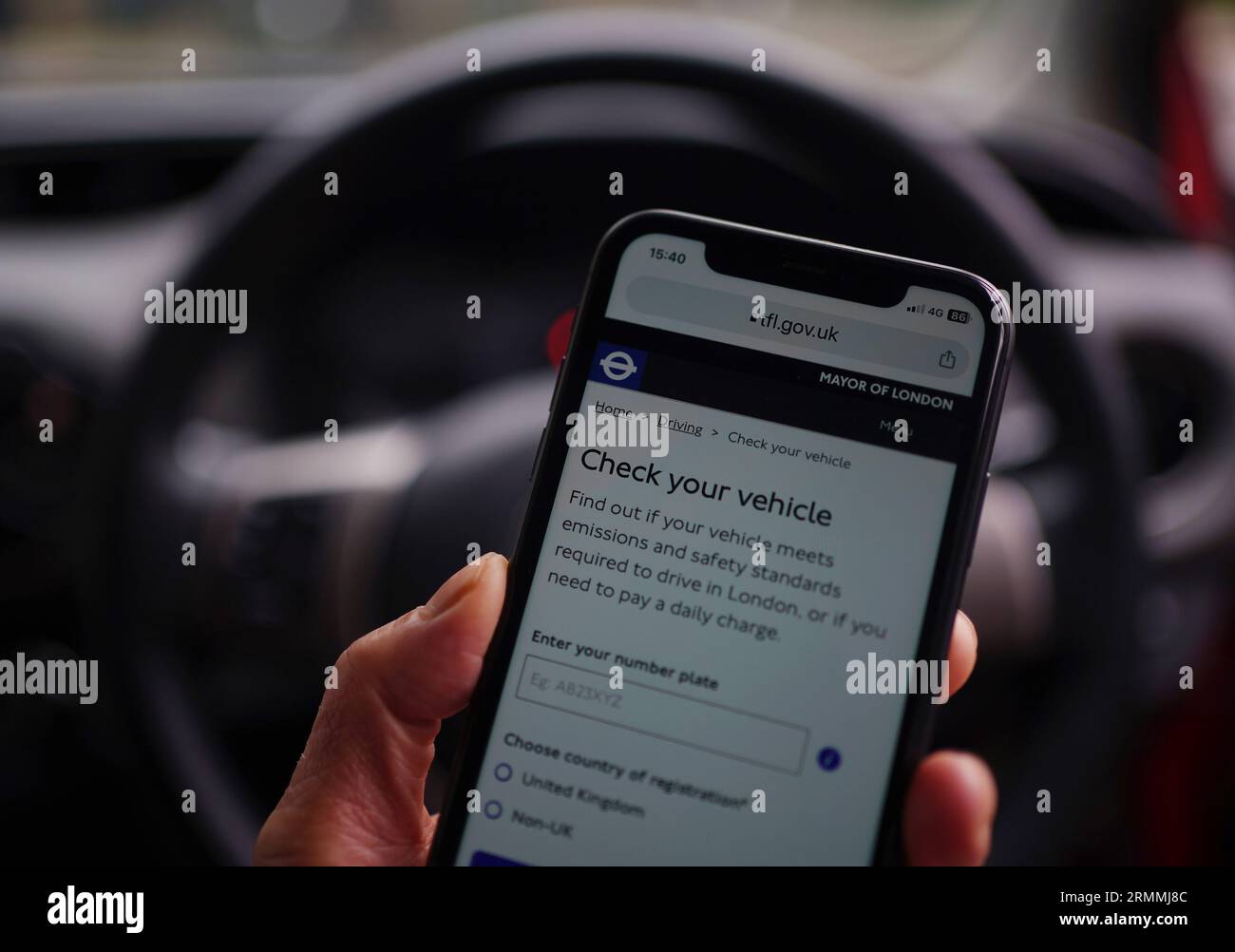 A person checks their vehicle on the Transport for London (TfL) webiste ...