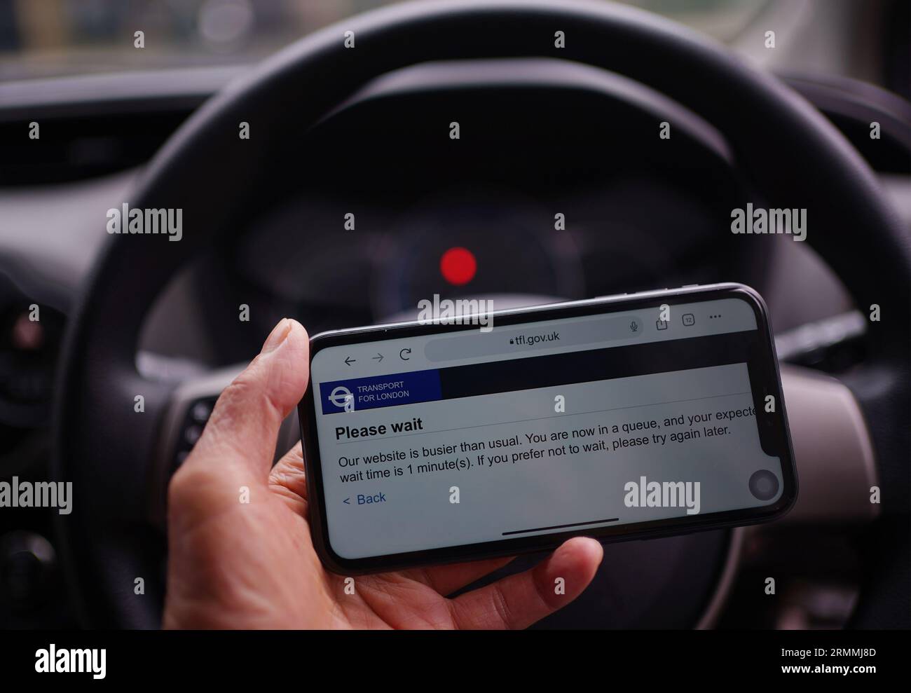 A person checks their vehicle on the Transport for London (TfL) webiste ...
