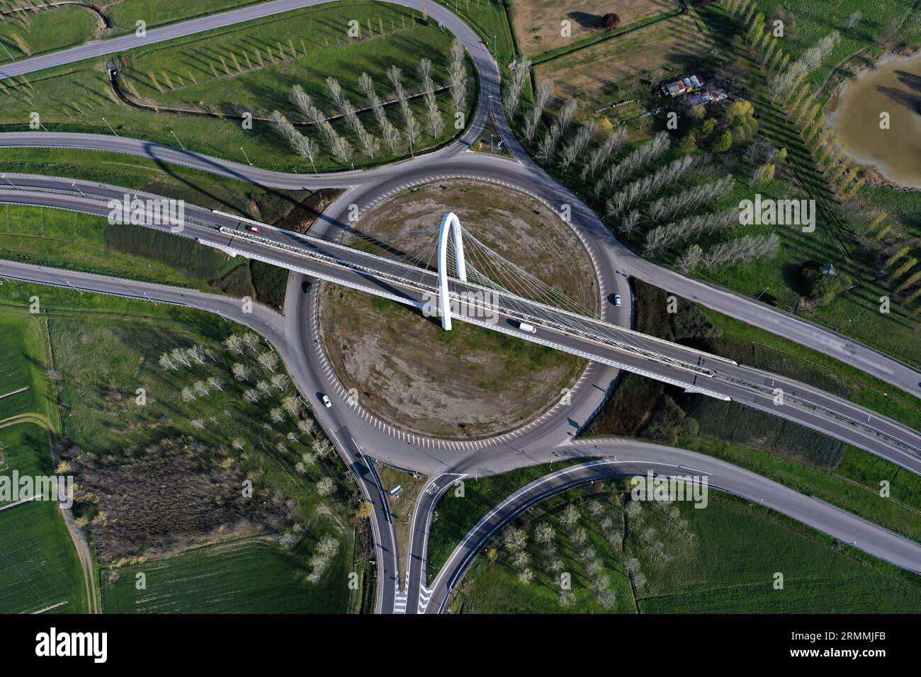Aerial zenithal view of a roundabout with an arch of the suspension ...