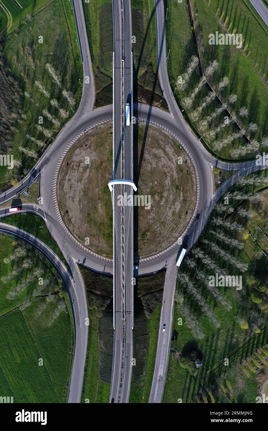 Aerial zenithal view of a roundabout with an arch of the suspension ...