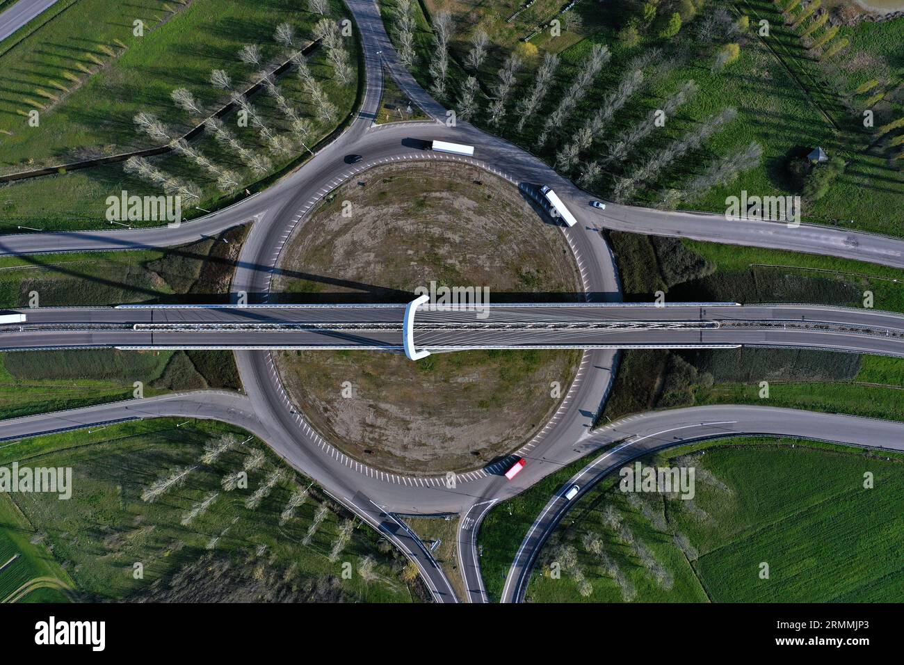 Aerial zenithal view of a roundabout with an arch of the suspension ...