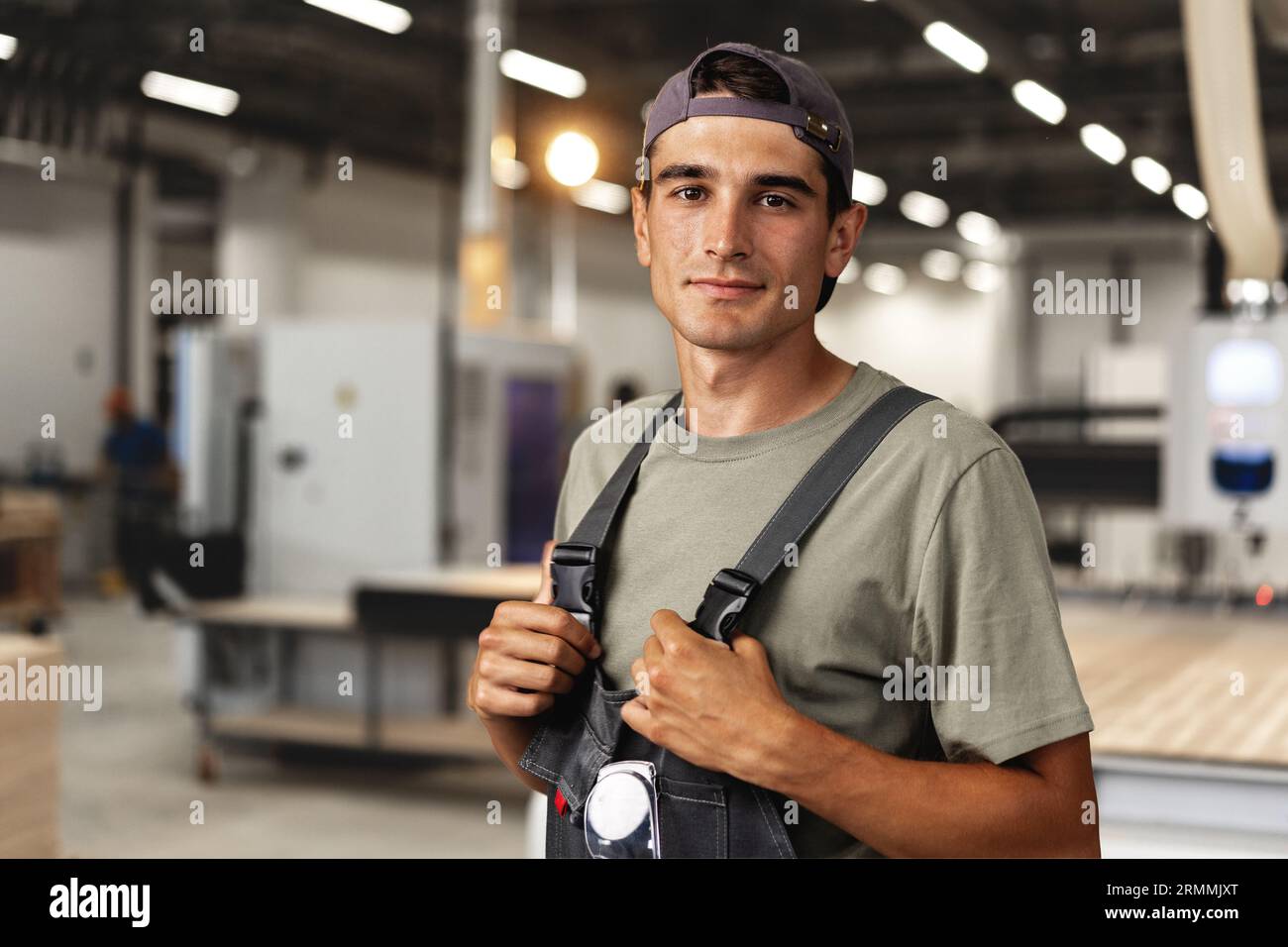 Portrait of young male carpenter standing in the wood workshop Stock ...