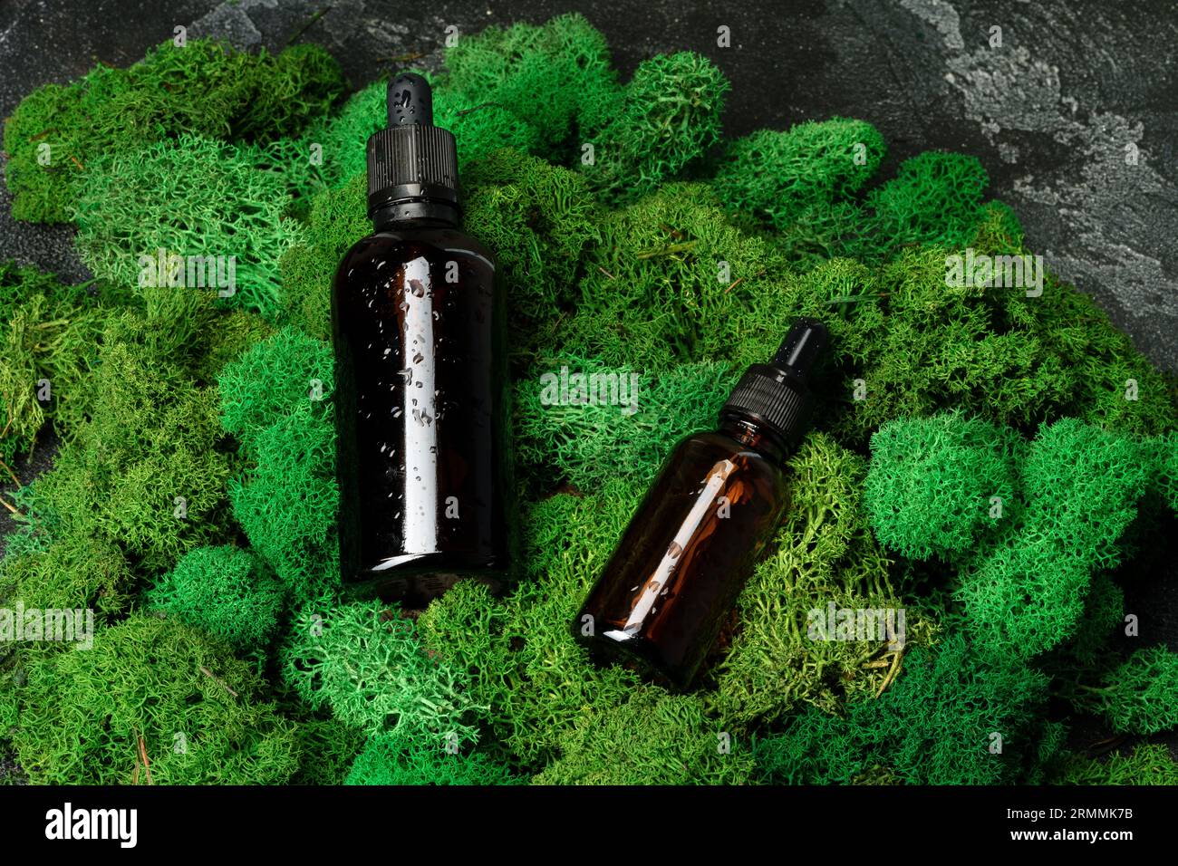 Vape smoking liquid bottles on moss background Stock Photo - Alamy