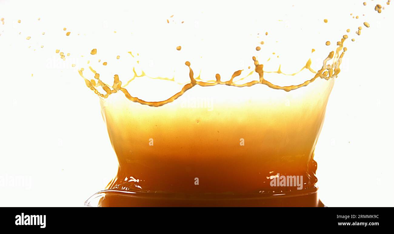 Orange Juice being poured into Glass against White Background Stock ...